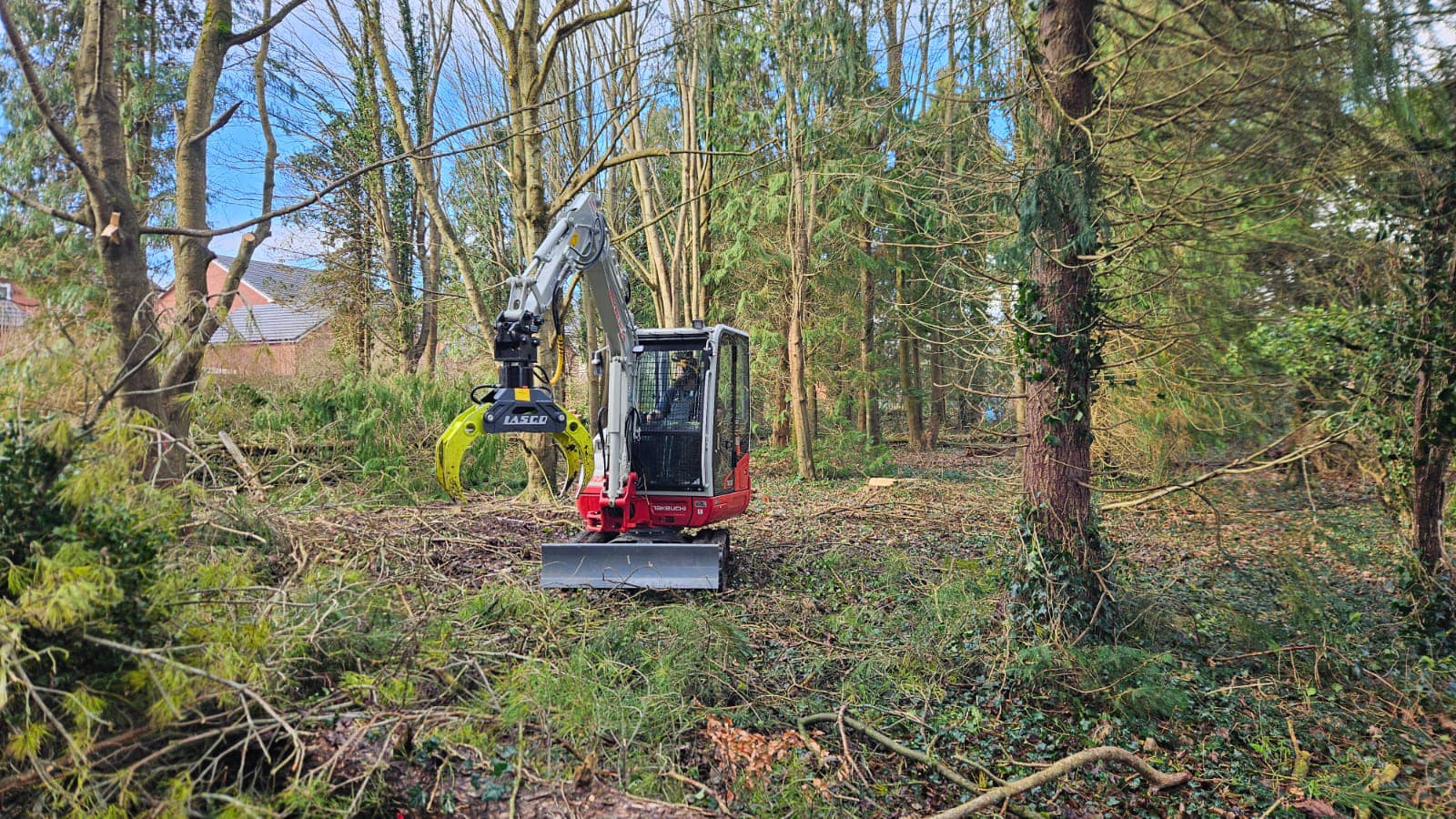Takeuchi moving brash and stacking ready for chipping March 2024 ...